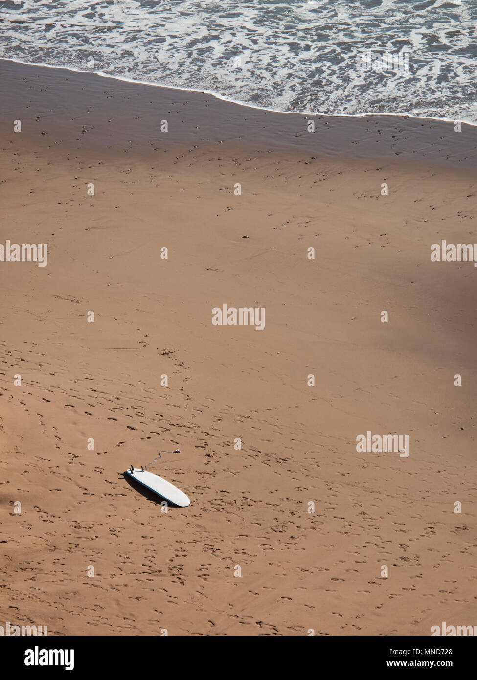 High angle view of surfboard on sand at beach Stock Photo - Alamy