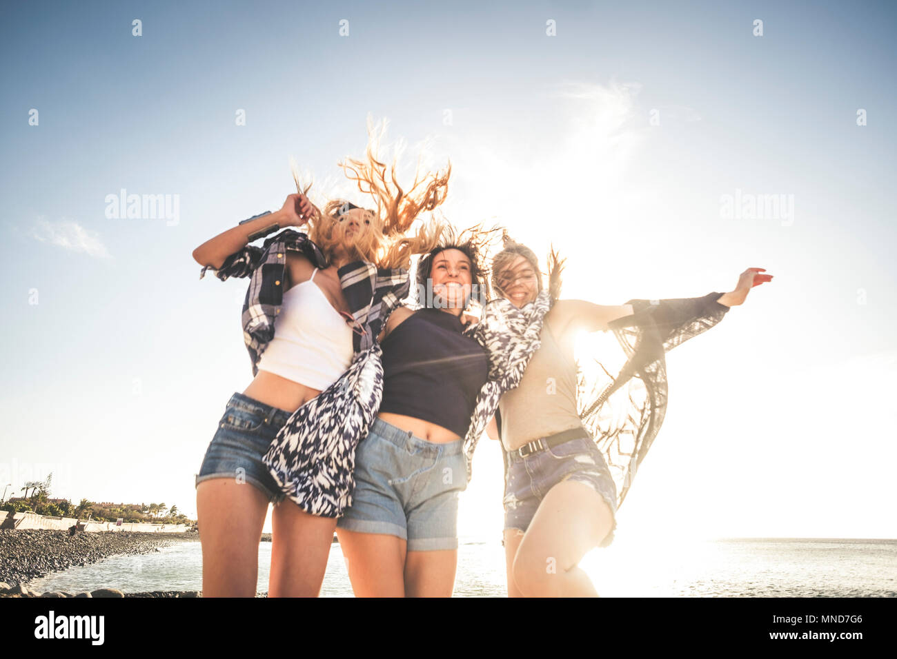 Group of three beautiful nice young woman jumping for fun and happiness ...