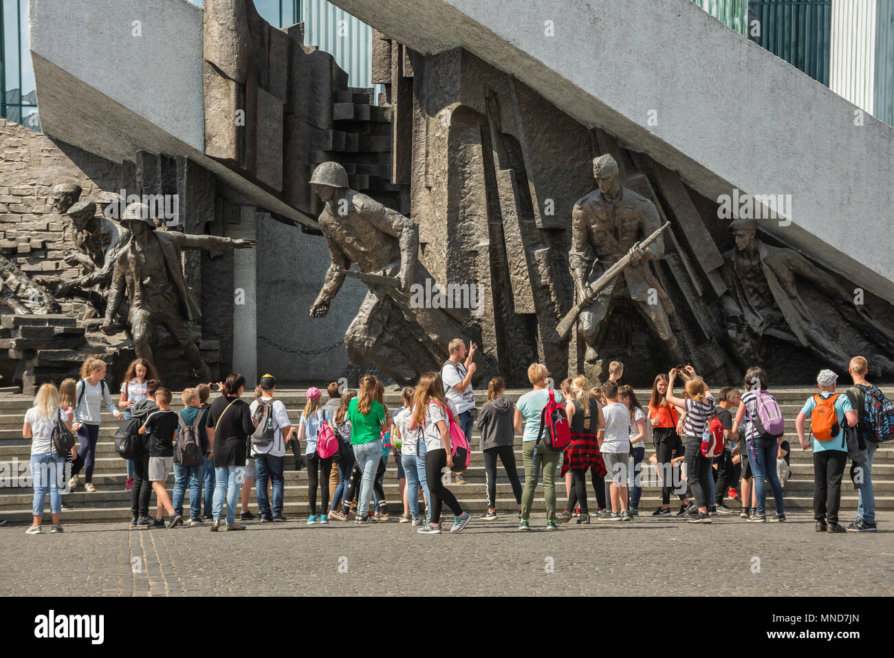 A group of teenage Polish students visit the Monument To The Warsaw ...