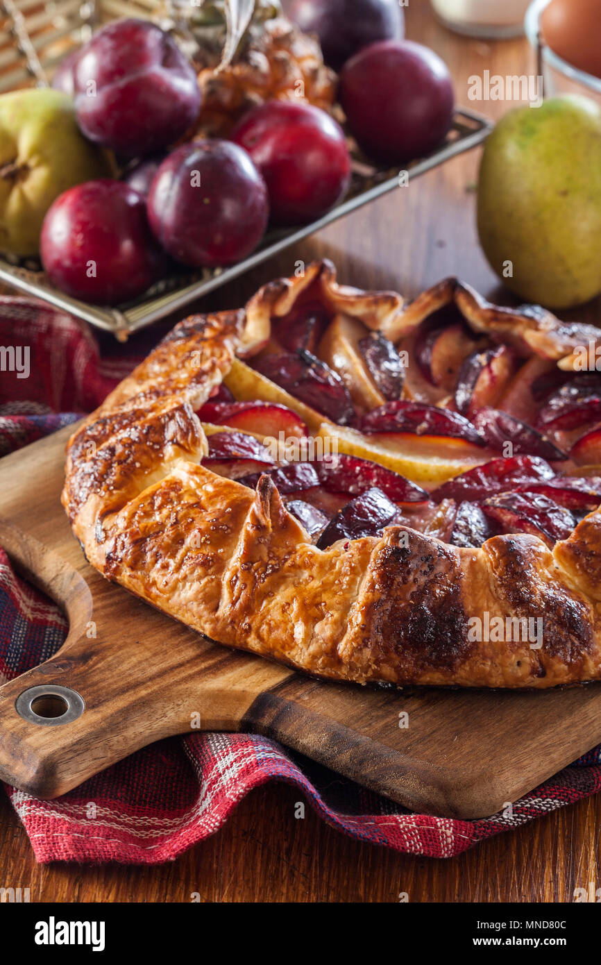 Galette with pears and plums. Rustic open pie. French cuisine Stock ...