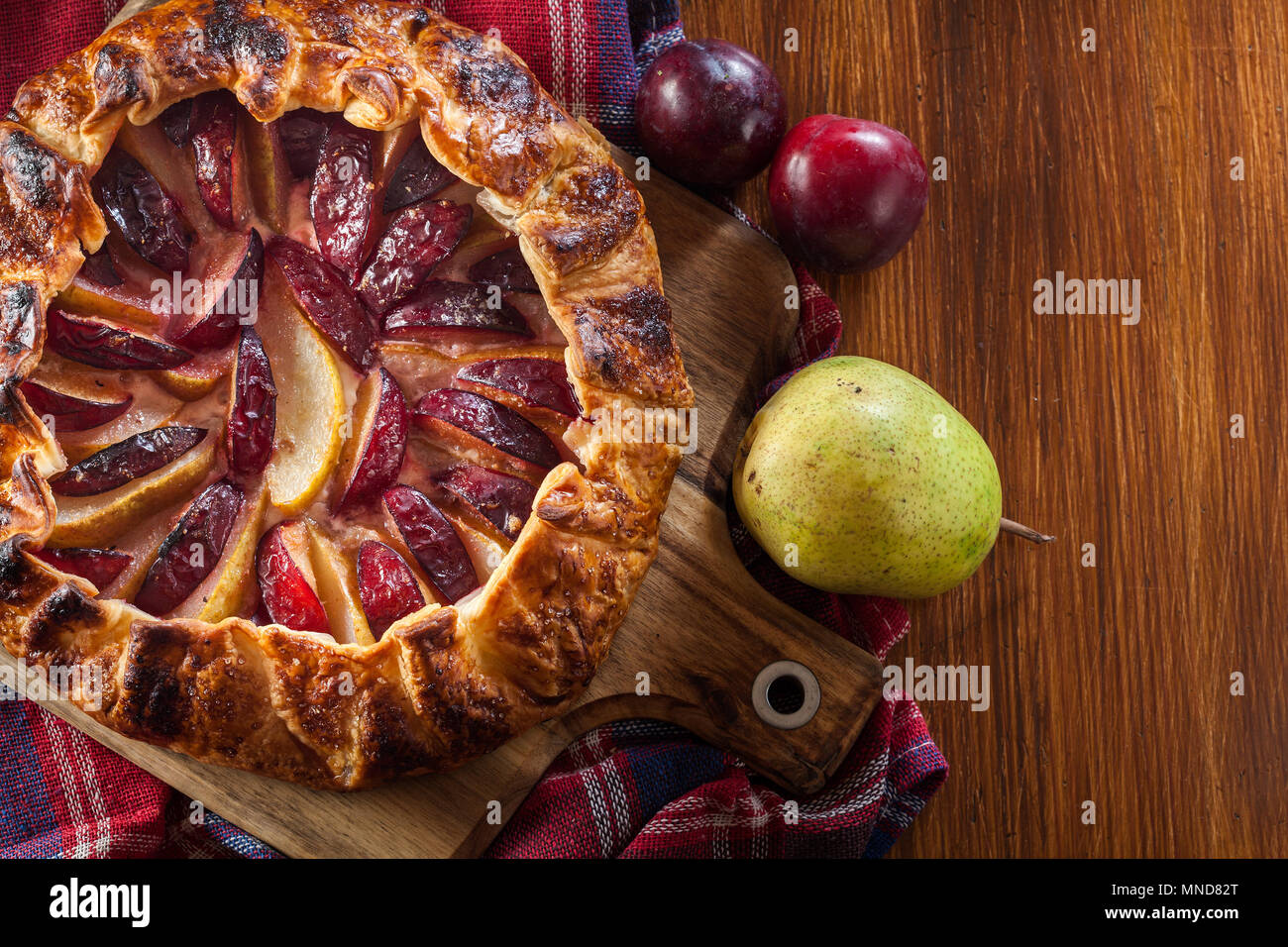 Galette with pears and plums. Rustic open pie. French cuisine Stock ...