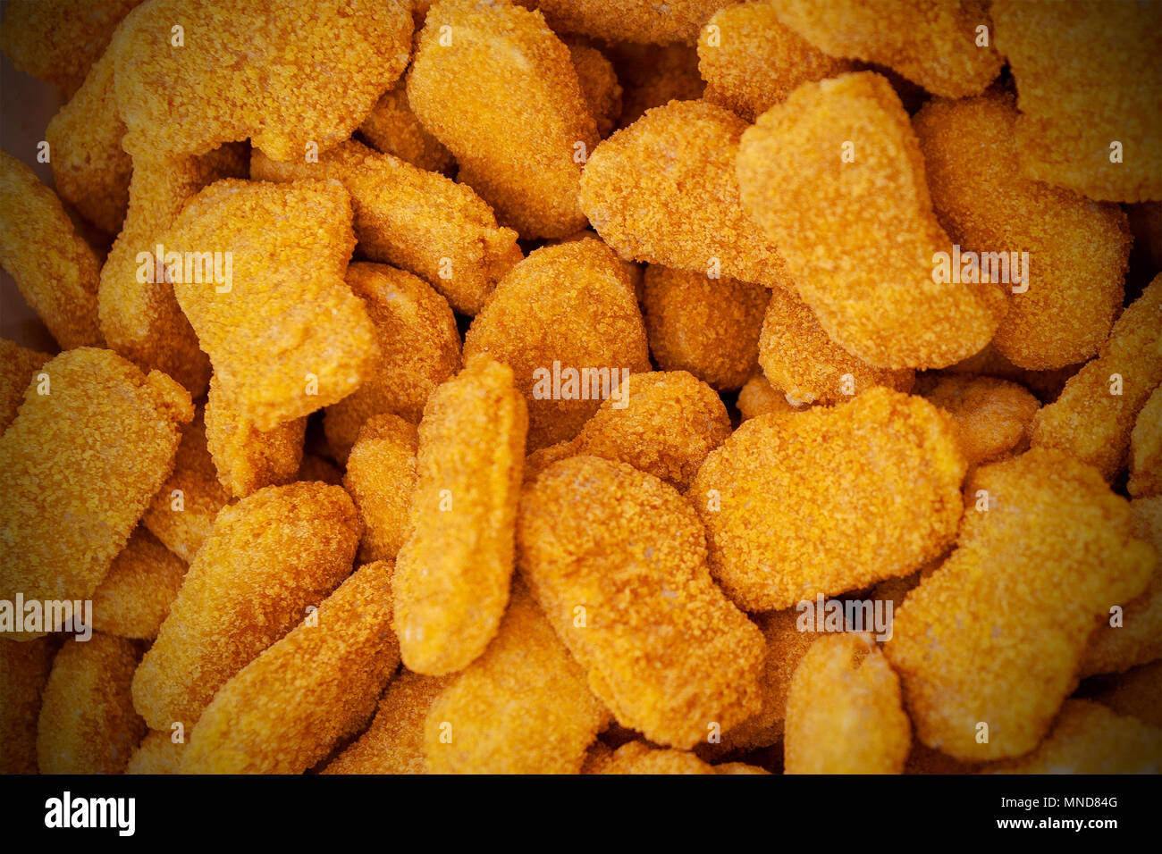 Frozen nuggets spread out evenly as a background Stock Photo - Alamy
