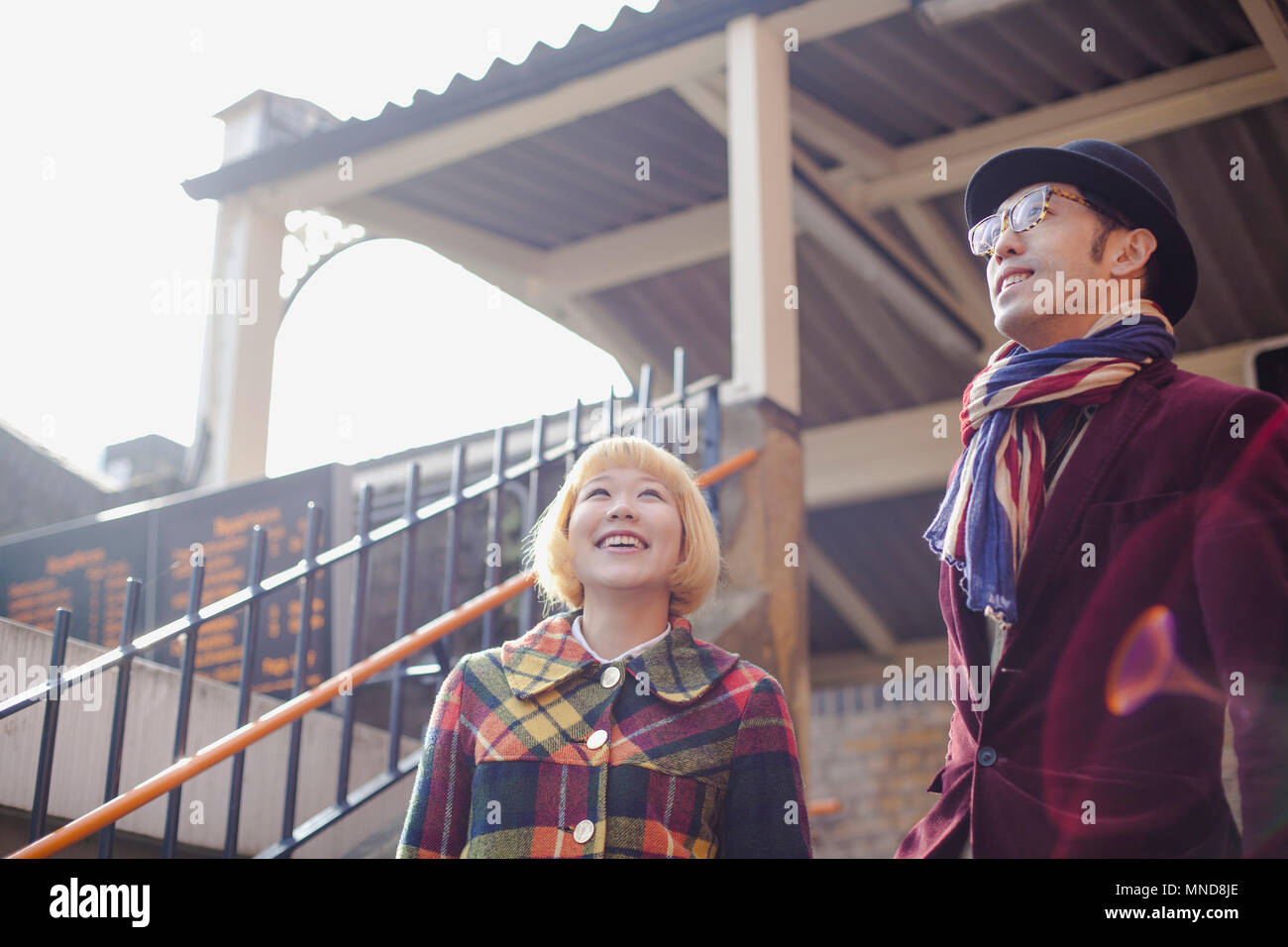 Low angle view of smiling couple standing against house Stock Photo - Alamy