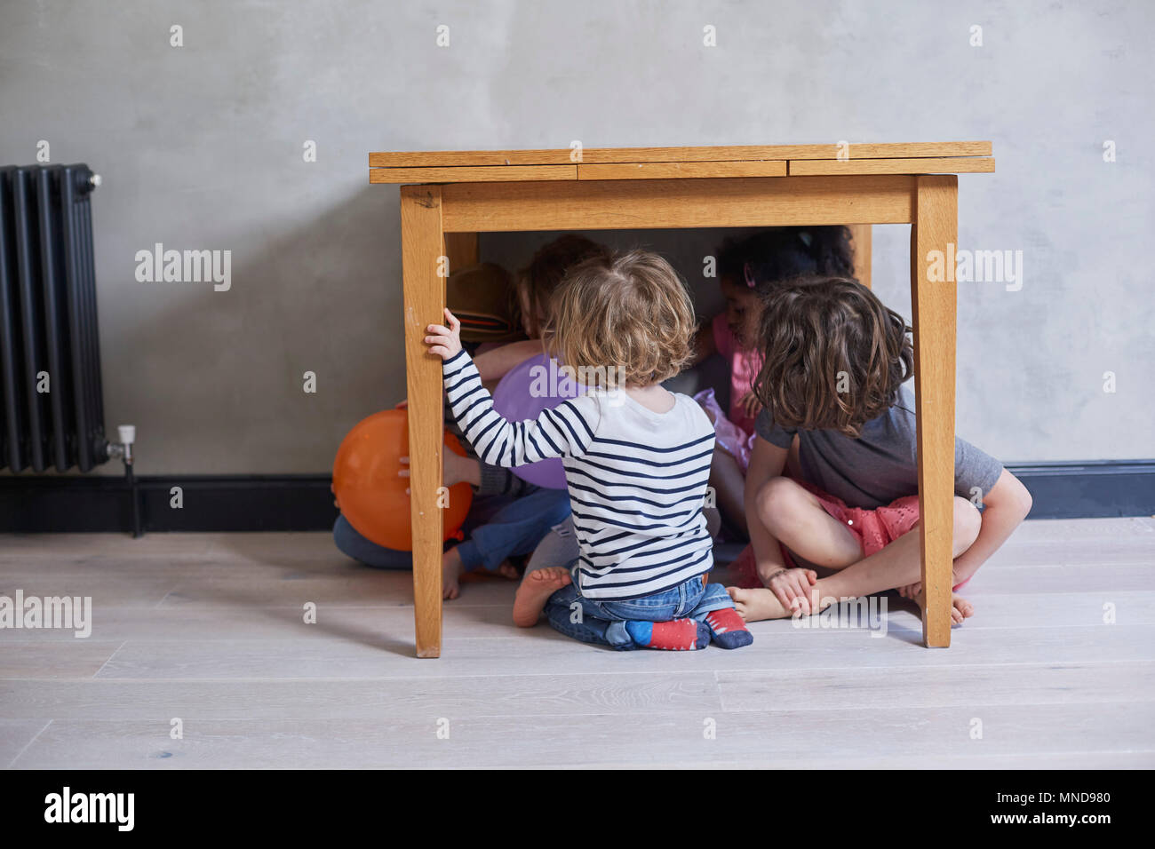 Children Hiding Under Desk