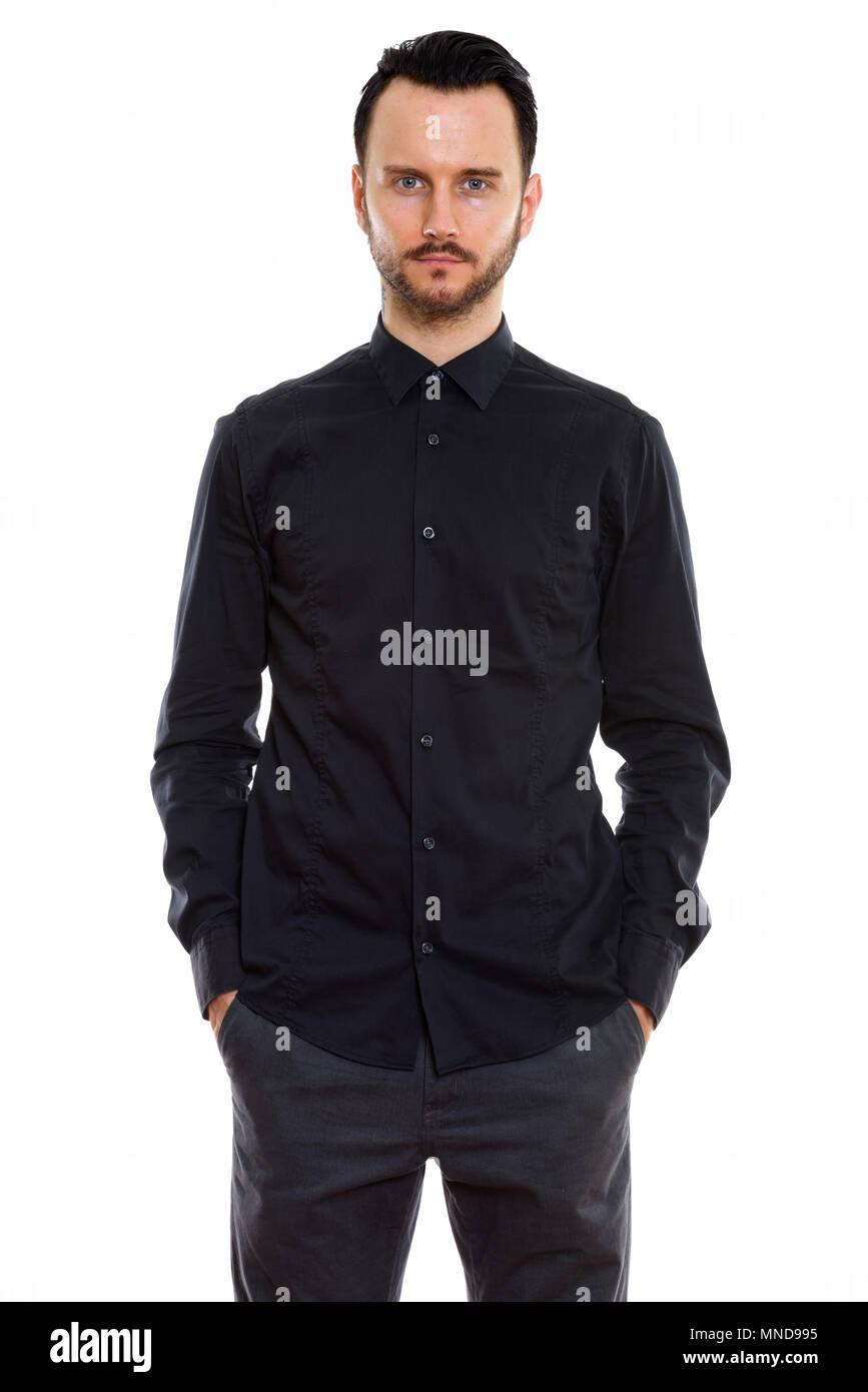 Studio shot of young man standing with hands on pockets Stock Photo - Alamy