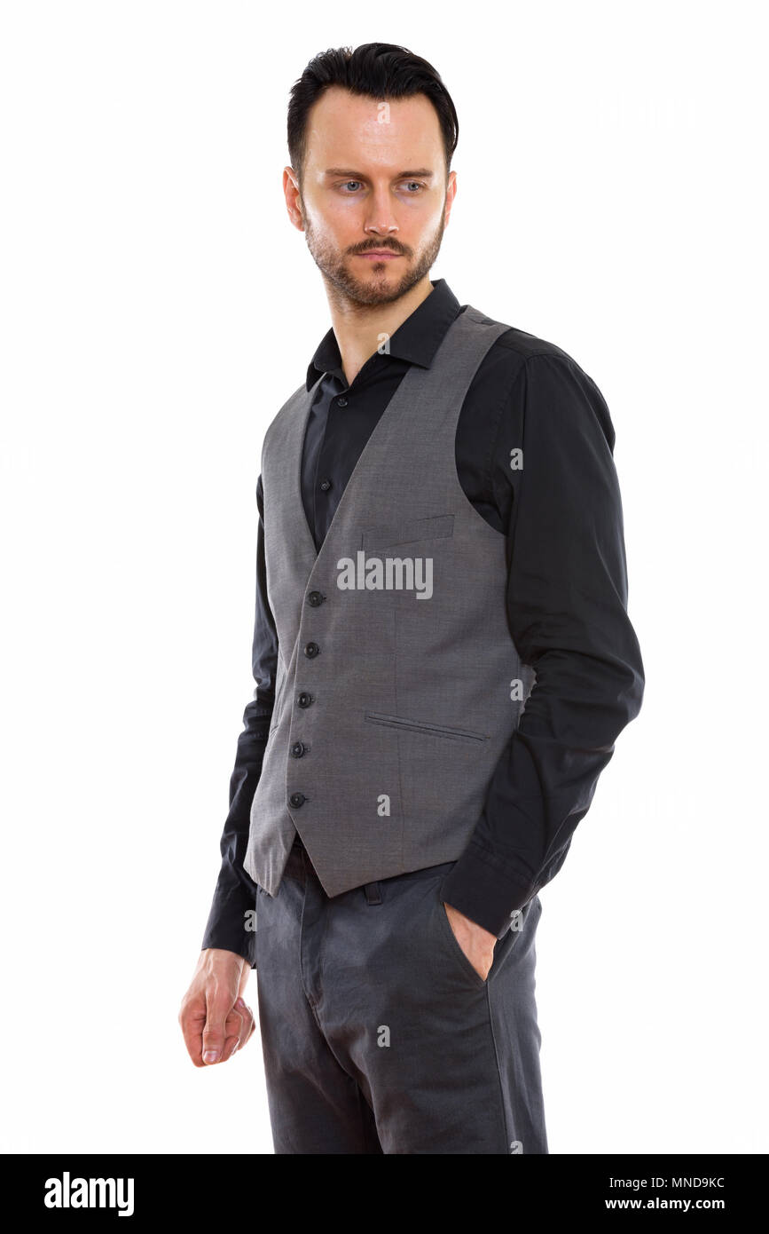 Studio shot of young man thinking while looking back Stock Photo - Alamy