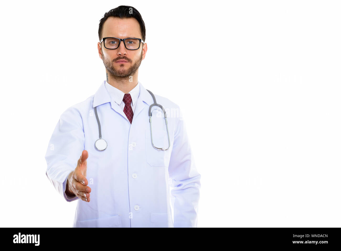 Studio shot of young man doctor giving handshake Stock Photo - Alamy