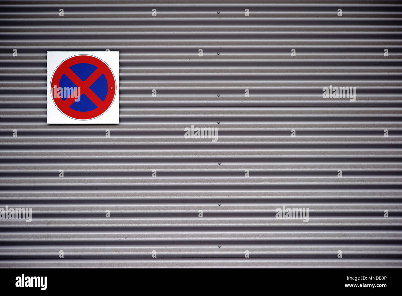 A no-stop sign bolted to a corrugated iron facade Stock Photo - Alamy