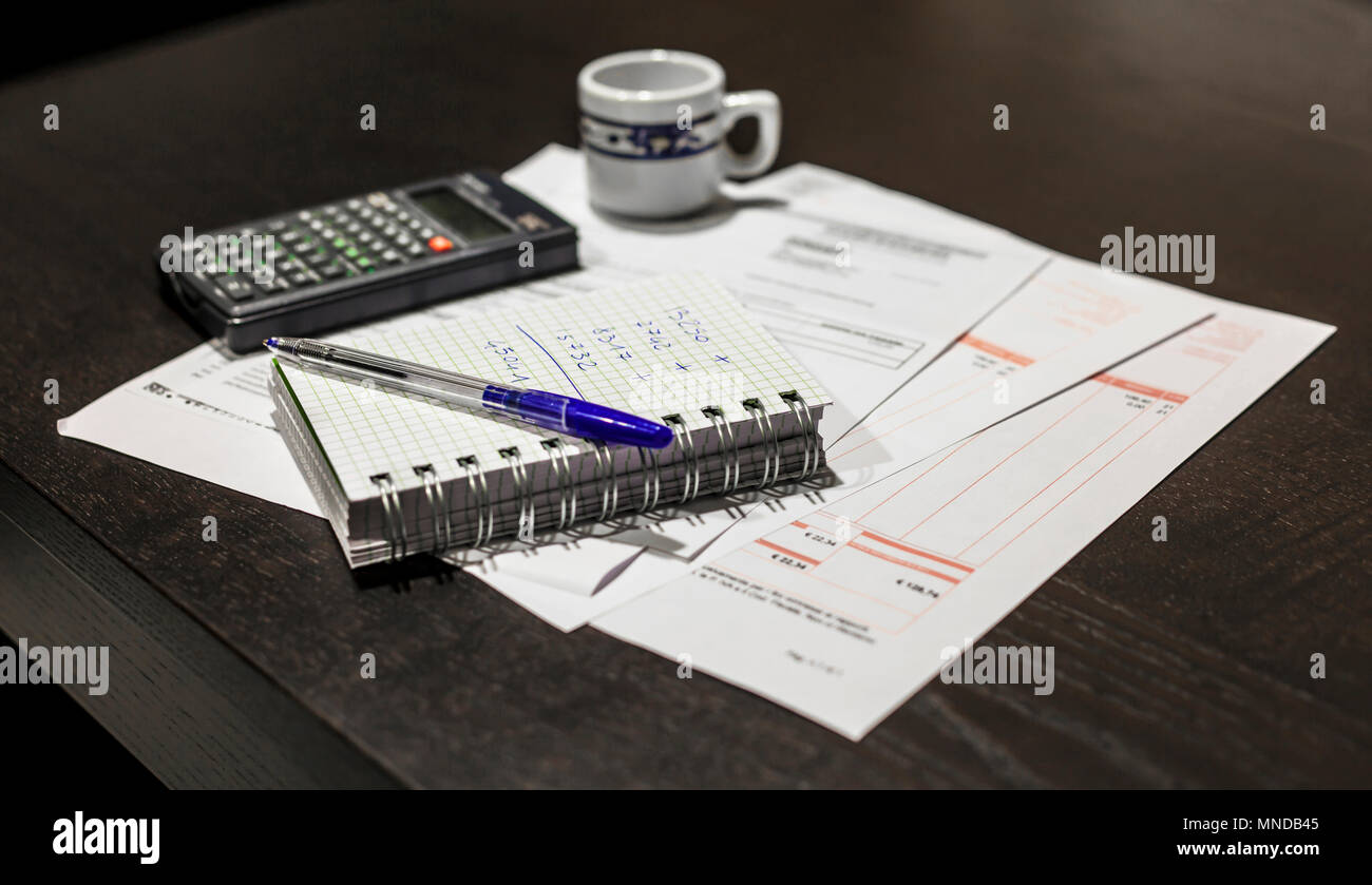 Calculation of the utility bills. Scene with pen, bills, calculator and ...