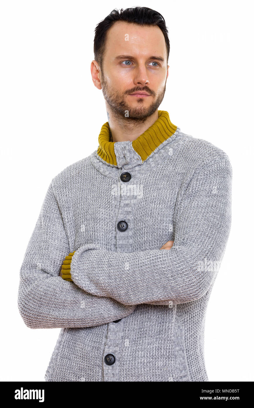 Studio shot of young man thinking with arms crossed Stock Photo - Alamy