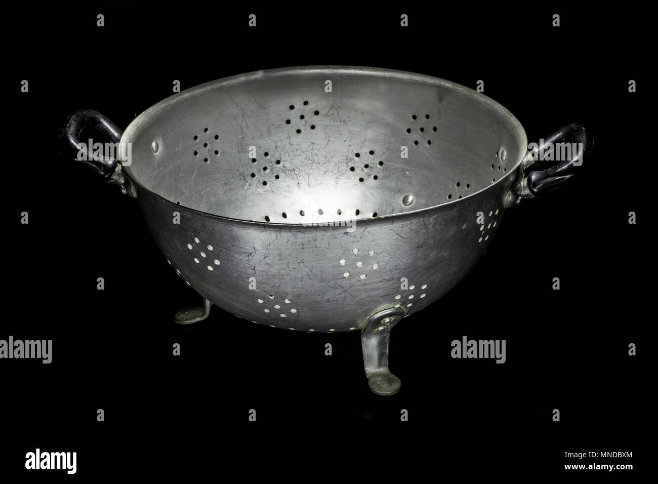 Old colander isolated on a black background. Studio shot Stock Photo ...