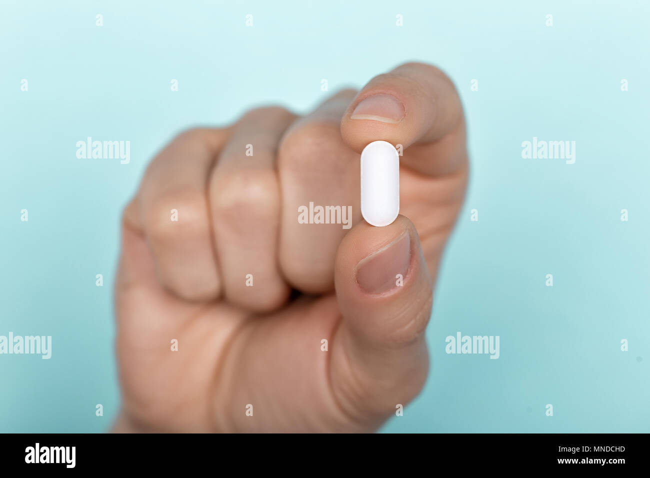 pill in man's hand on white background Stock Photo - Alamy