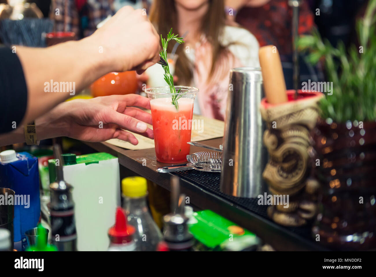 Expert pro barman hands is making cocktail and decorating drink with ...