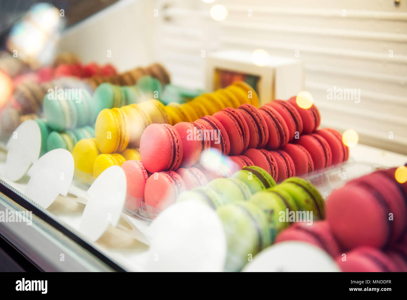 Assortment of Colorful macarons for sale in shop. Rows of macaroons in ...