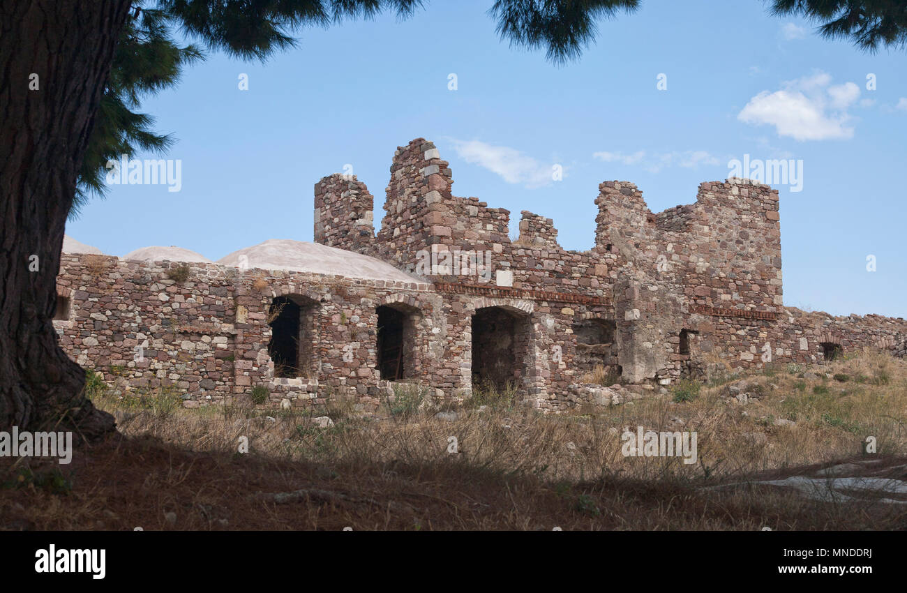 The east wall of the Mytilene Fort in Greece framed by a large tree ...
