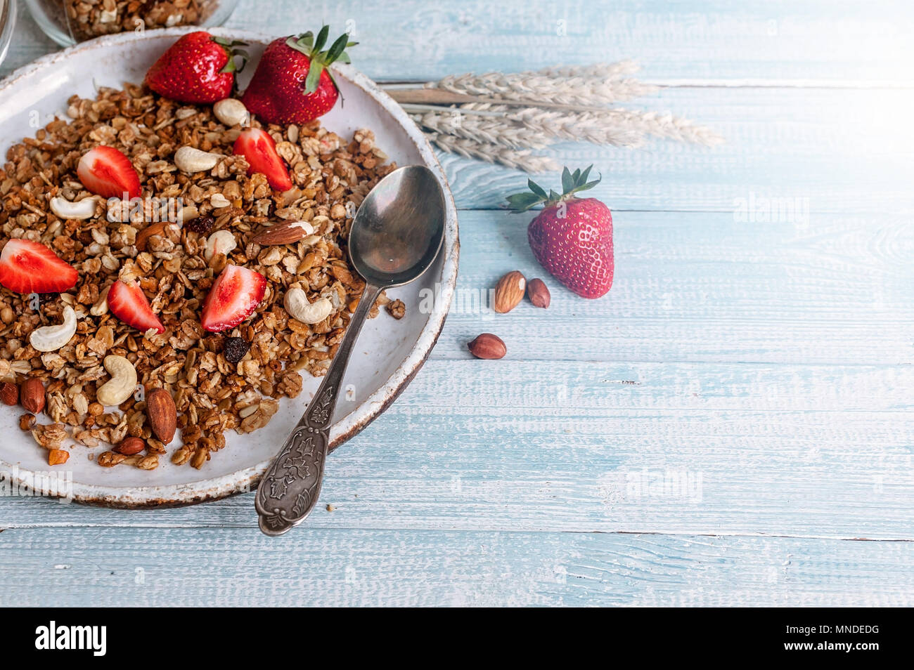 Granola with nuts and fresh strawberries on a wooden rustic background ...