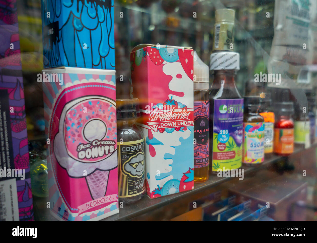 A selection of flavored vaping supplies on display in the window of a ...