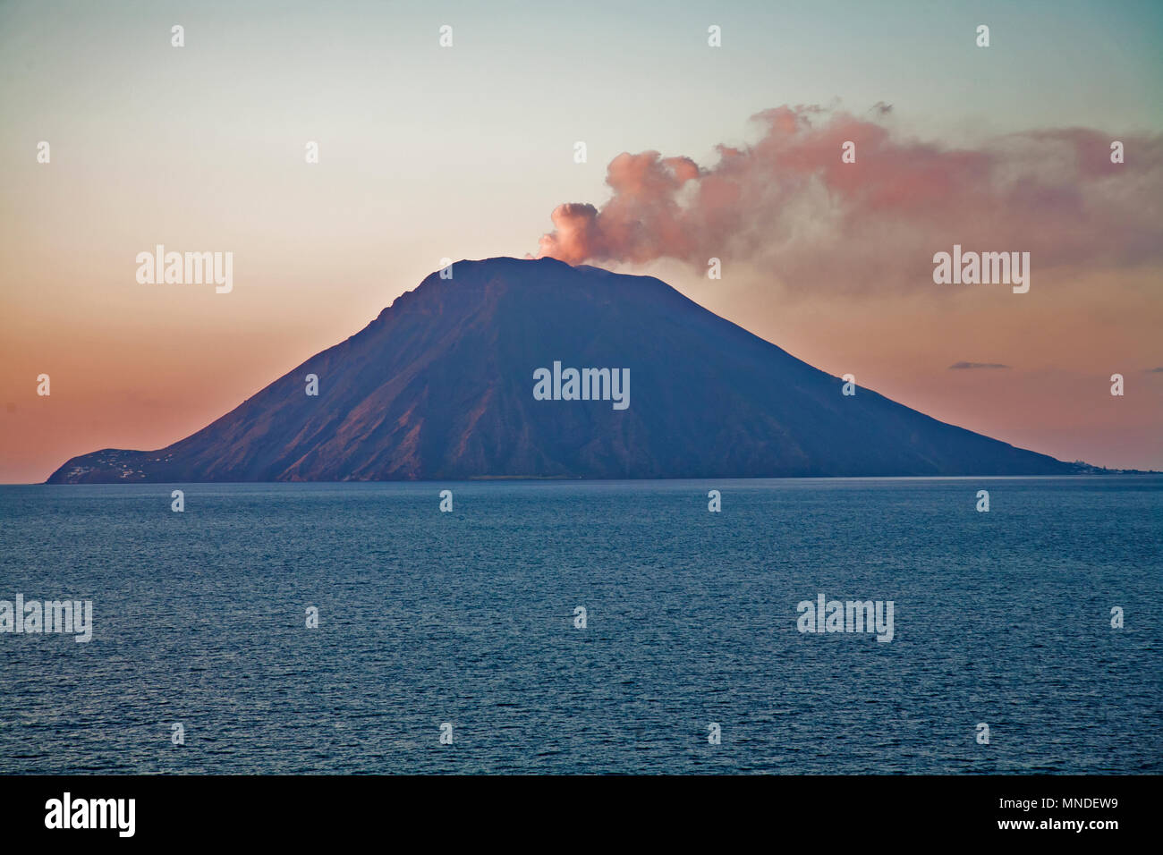 Sun going down in a pink sky in Italy's Stromboli volcano region Stock ...