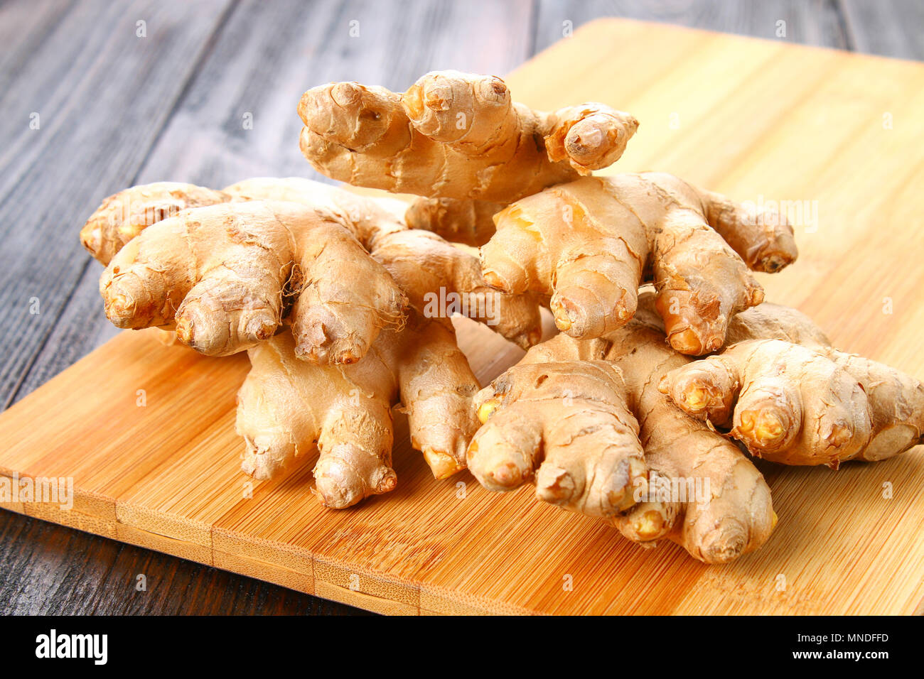 Spicy root of ginger on a wooden table Stock Photo - Alamy