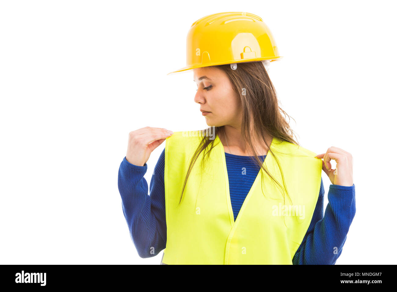 Young female engineer or architect adjusting her vest with hands as ...