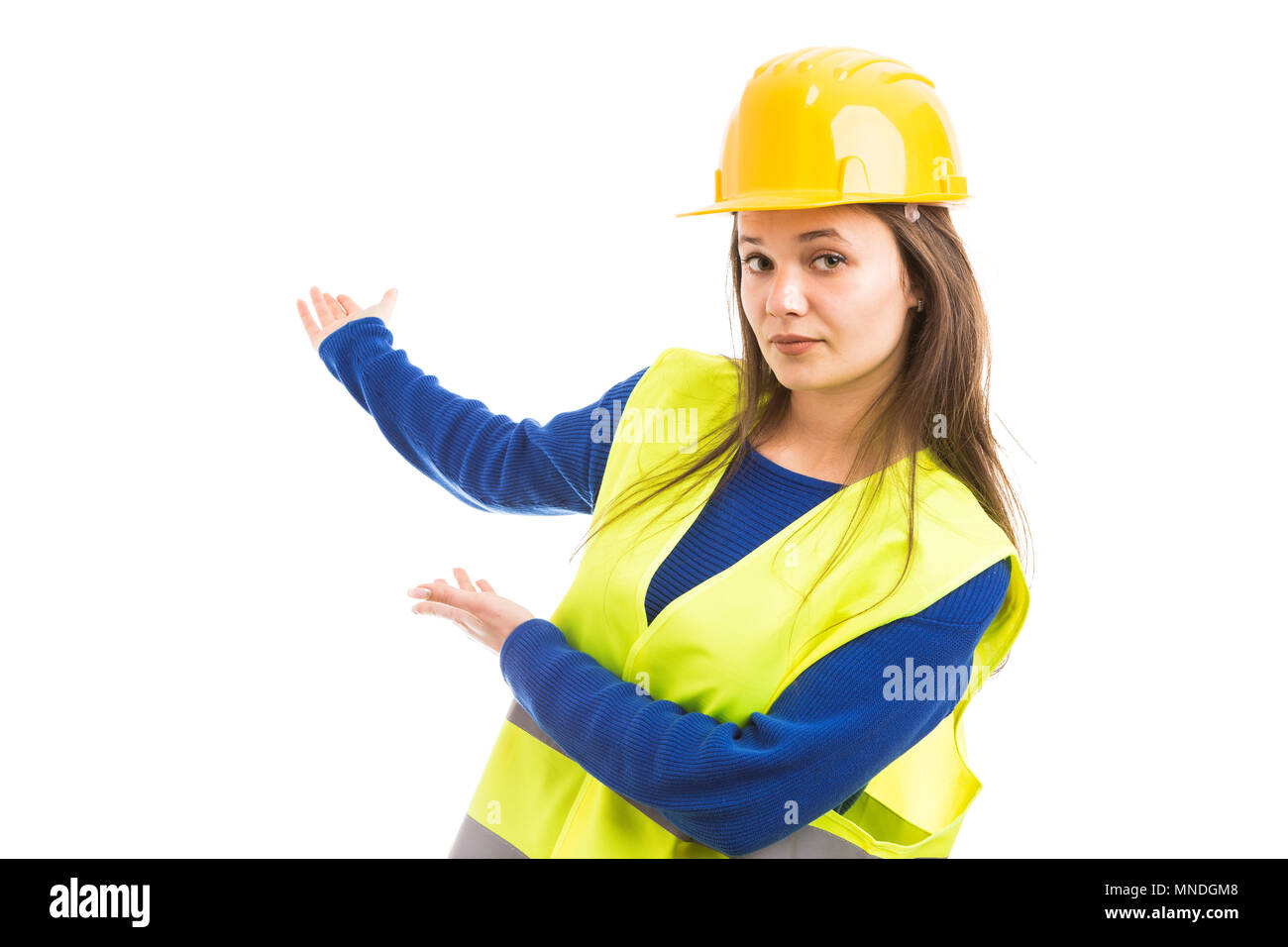 Young female engineer or architect making presentation gesture with ...