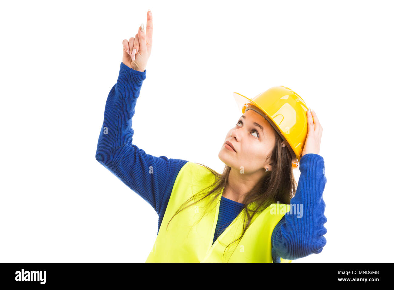 Young beautiful female engineer or architect pointing up with index ...
