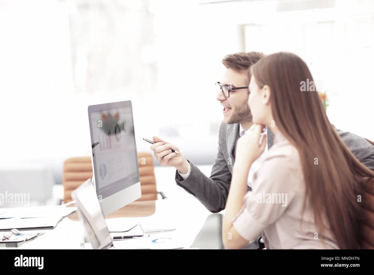Two managers in a business meeting analyzing data Stock Photo - Alamy