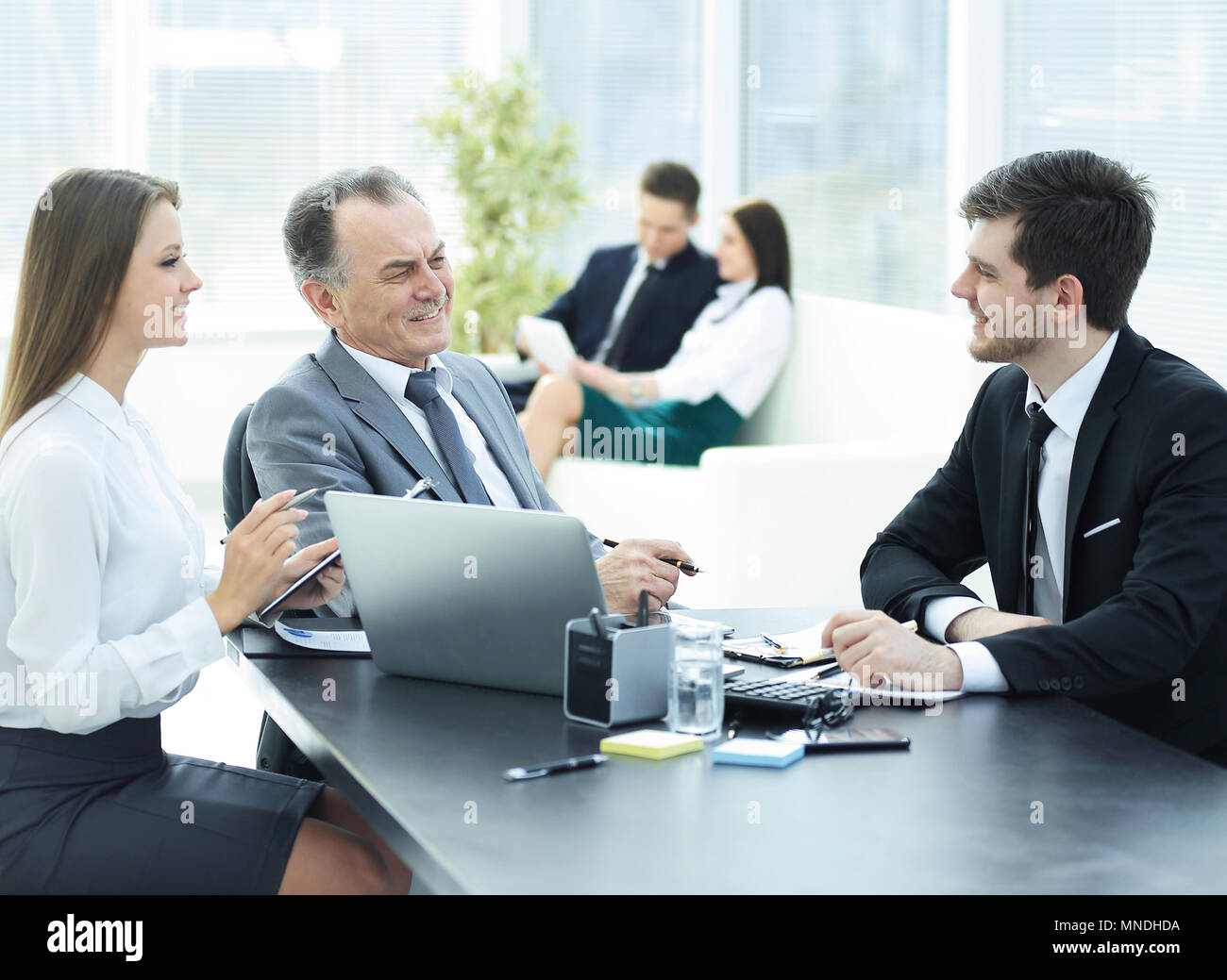 client talking with the staff at the Desk in the office Stock Photo - Alamy