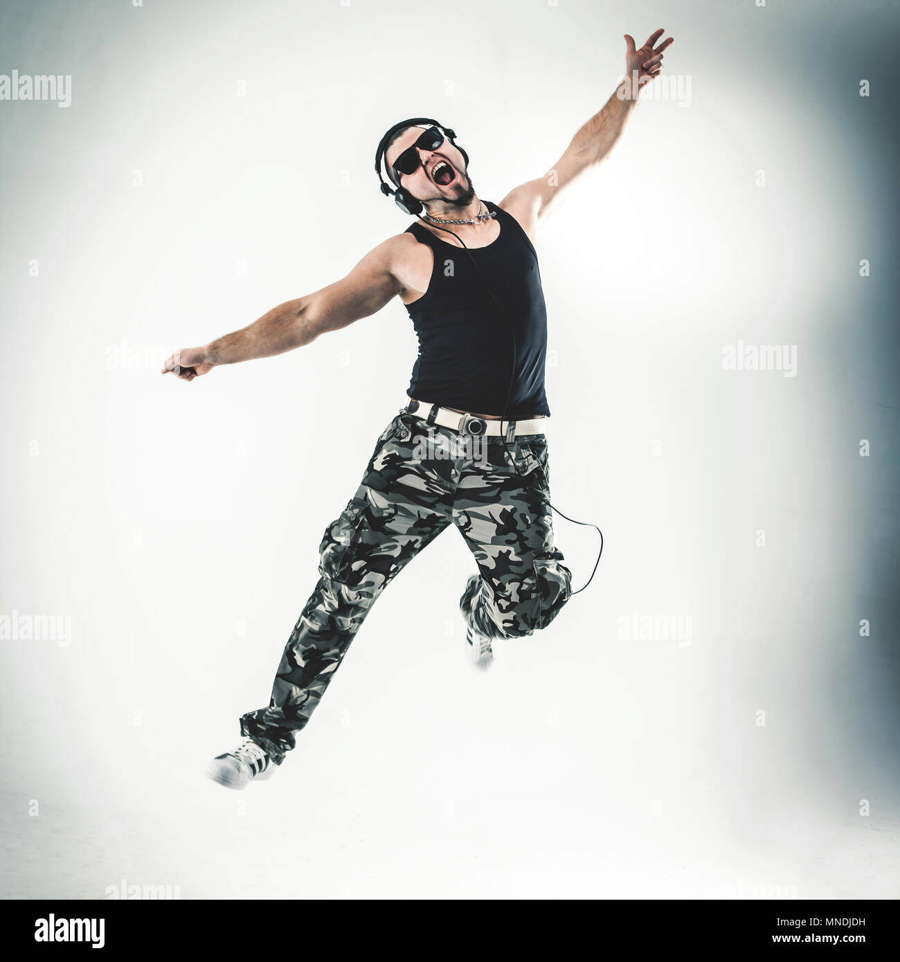 emotional and charismatic DJ - rapper in headphones takes the ra Stock ...