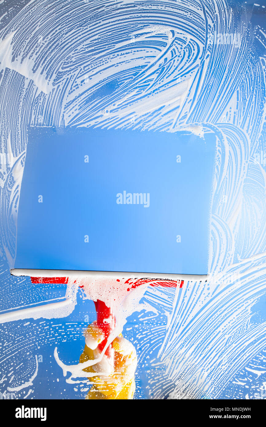 cleaning window with squeegee blue sky Stock Photo - Alamy