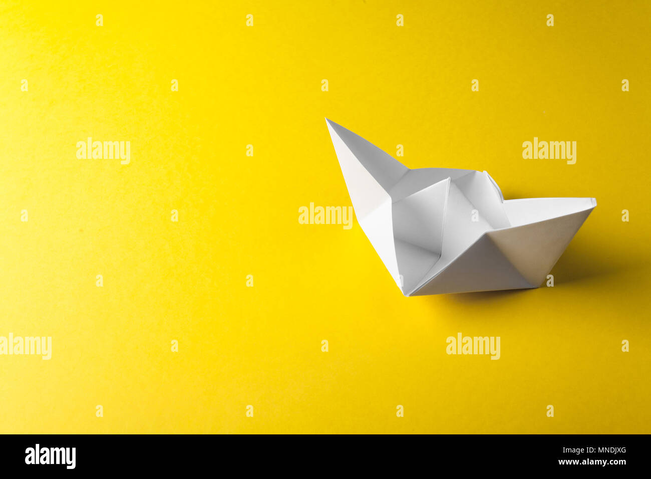 boat paper origami on the yellow background Stock Photo - Alamy