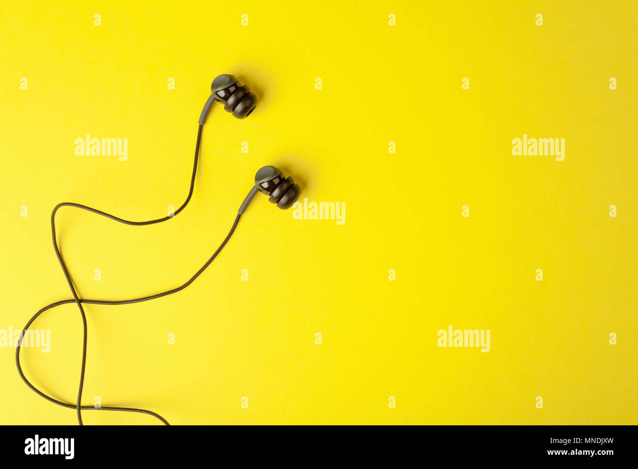 headphones on a yellow background Stock Photo - Alamy