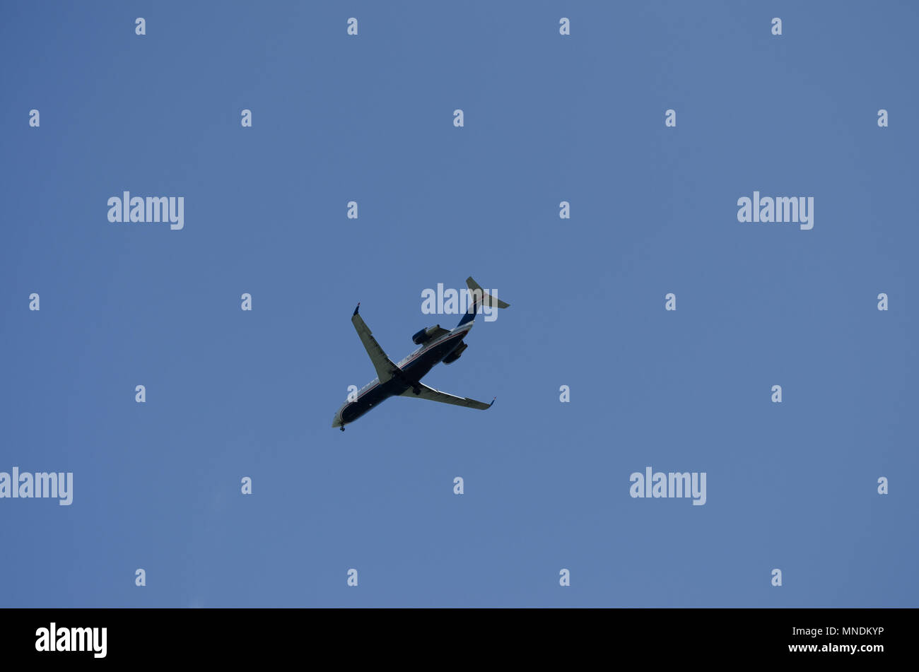 airplane flying with blue sky background Stock Photo - Alamy