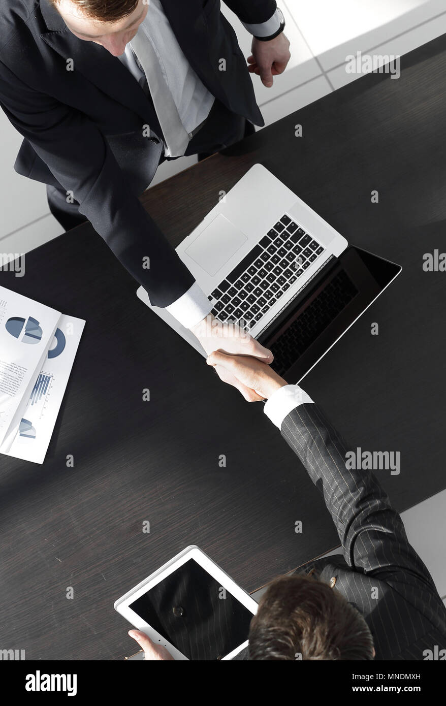 handshake of business partners above the Desk Stock Photo - Alamy