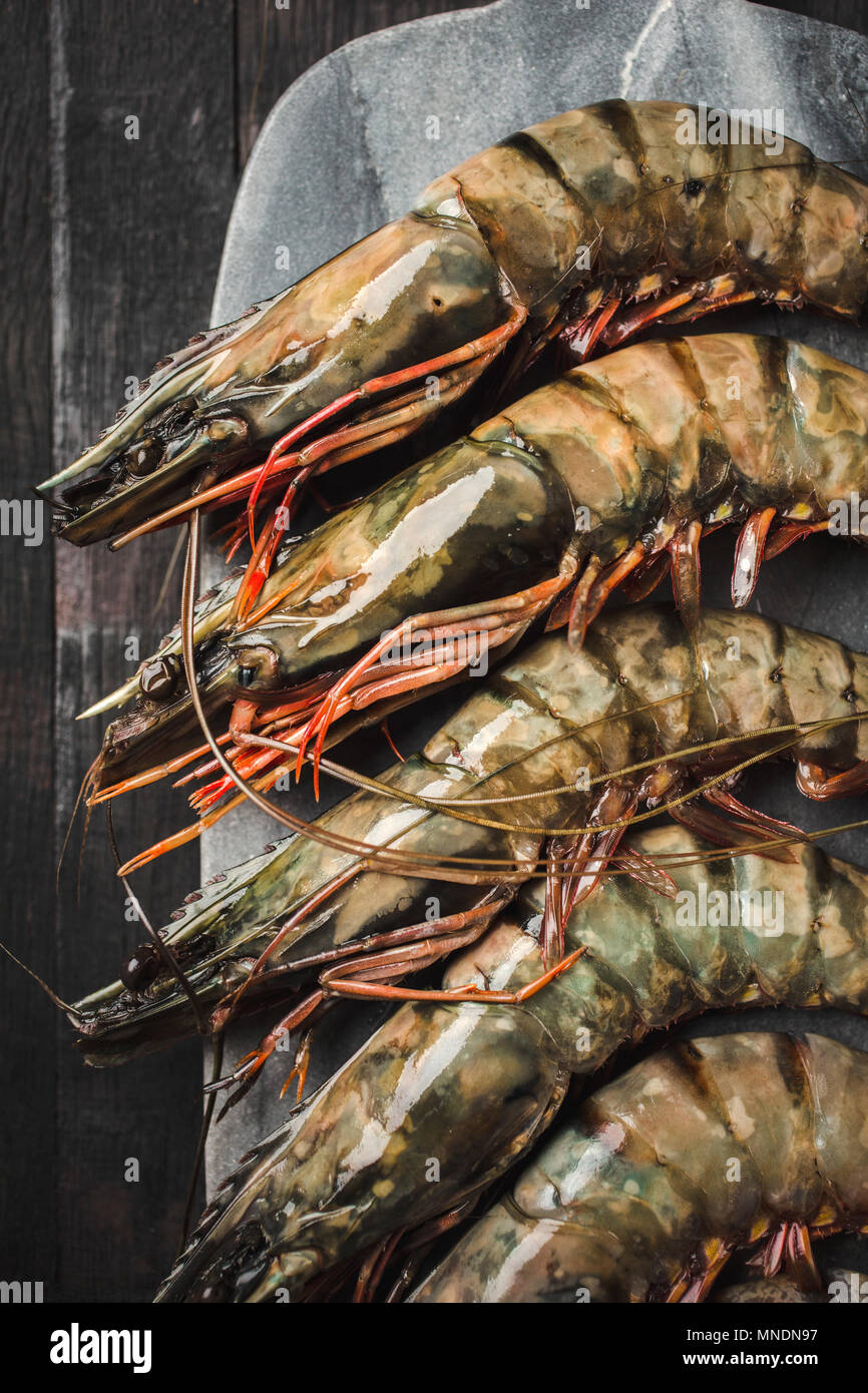 Raw prawns in shells on a stone board, top view Stock Photo - Alamy
