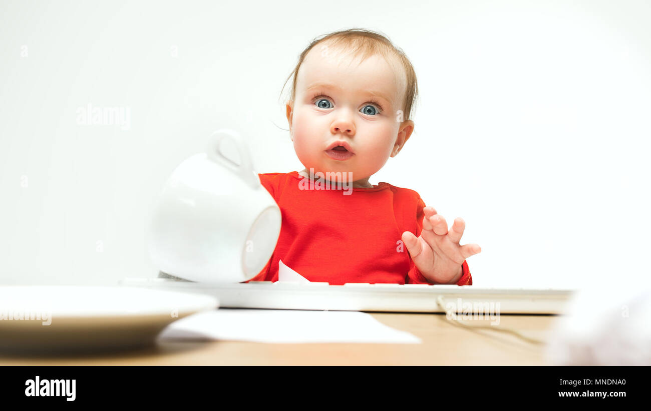 Happy child baby girl toddler sitting with keyboard of computer ...