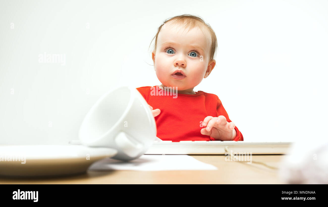 Happy child baby girl toddler sitting with keyboard of computer ...