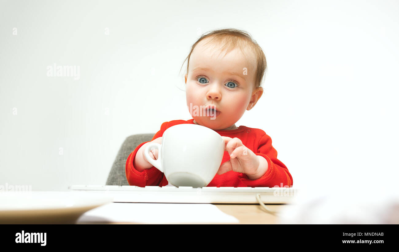 Happy child baby girl toddler sitting with keyboard of computer ...