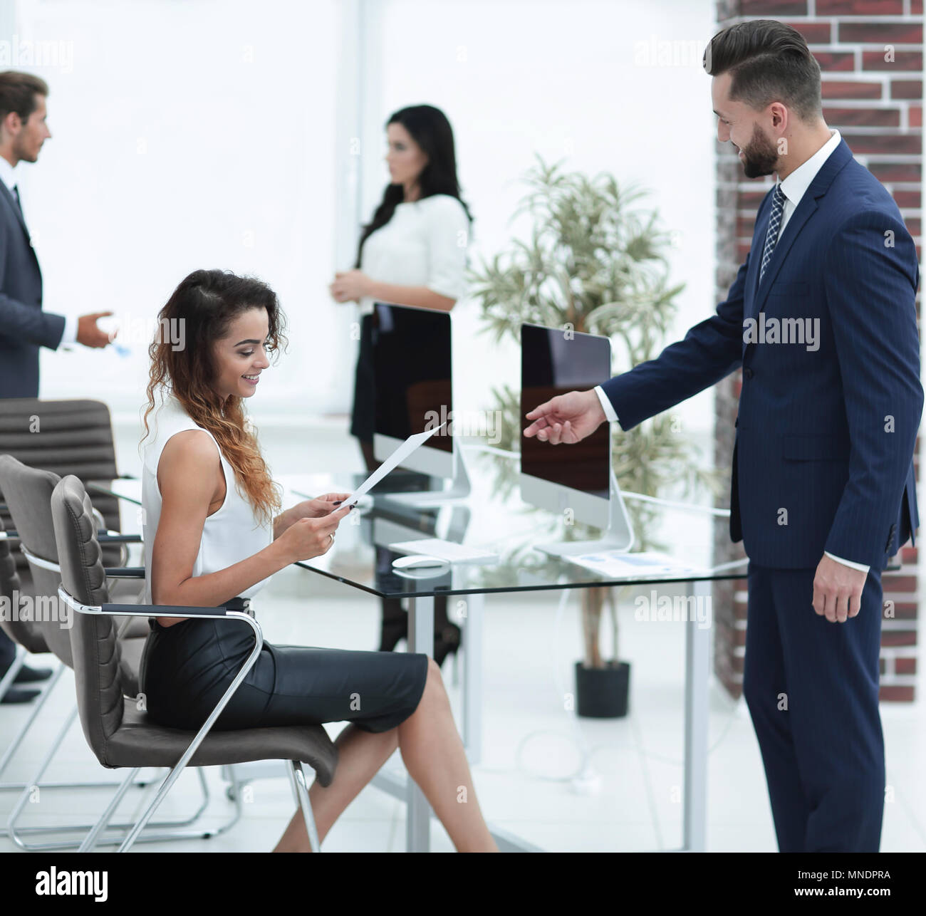 Manager discussing with an employee document Stock Photo - Alamy