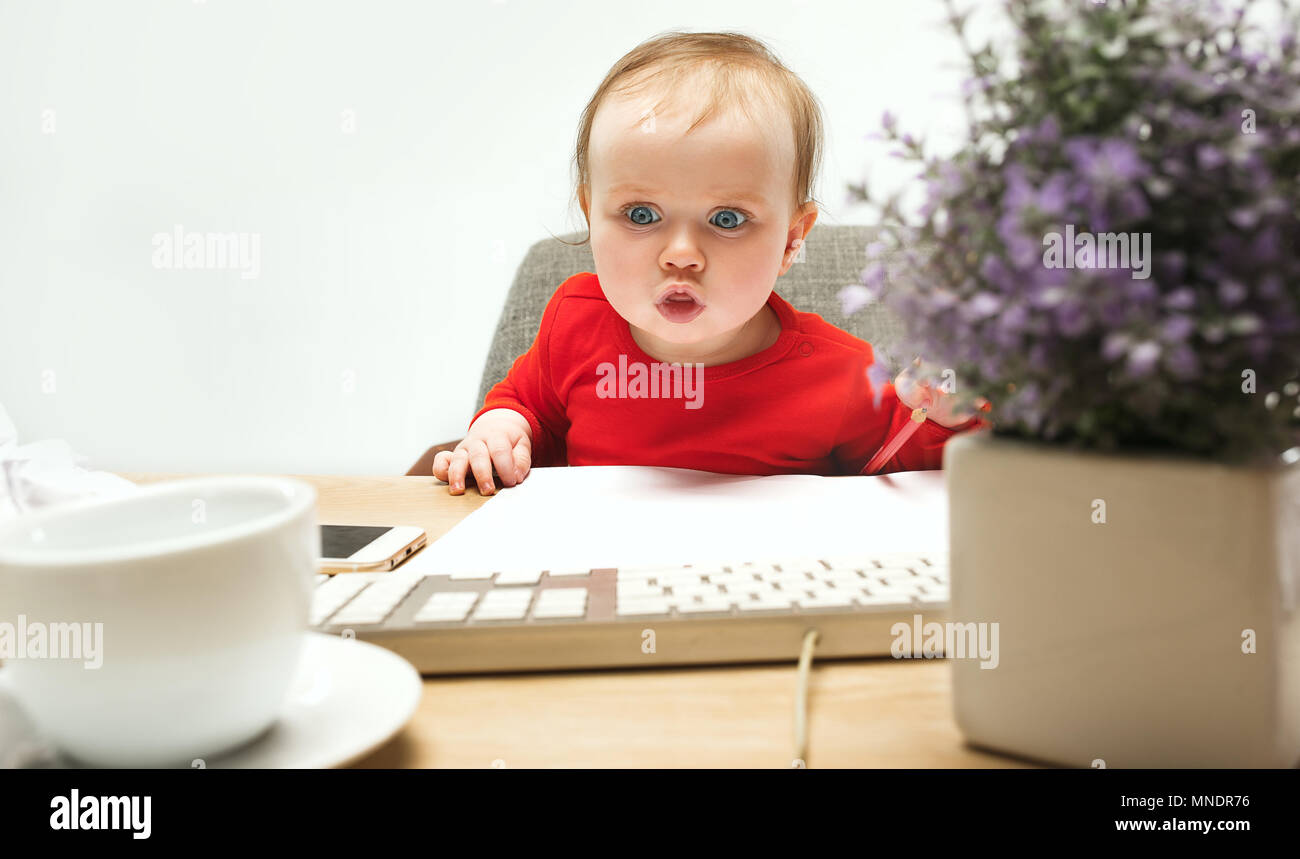 Happy child baby girl toddler sitting with keyboard of computer ...