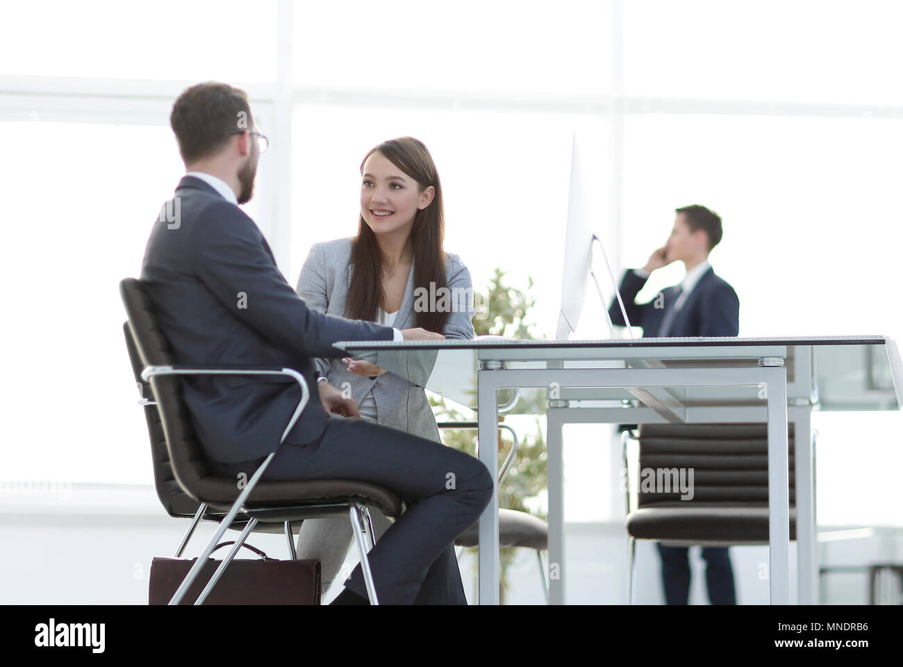 business colleagues talking, sitting behind a Desk Stock Photo - Alamy