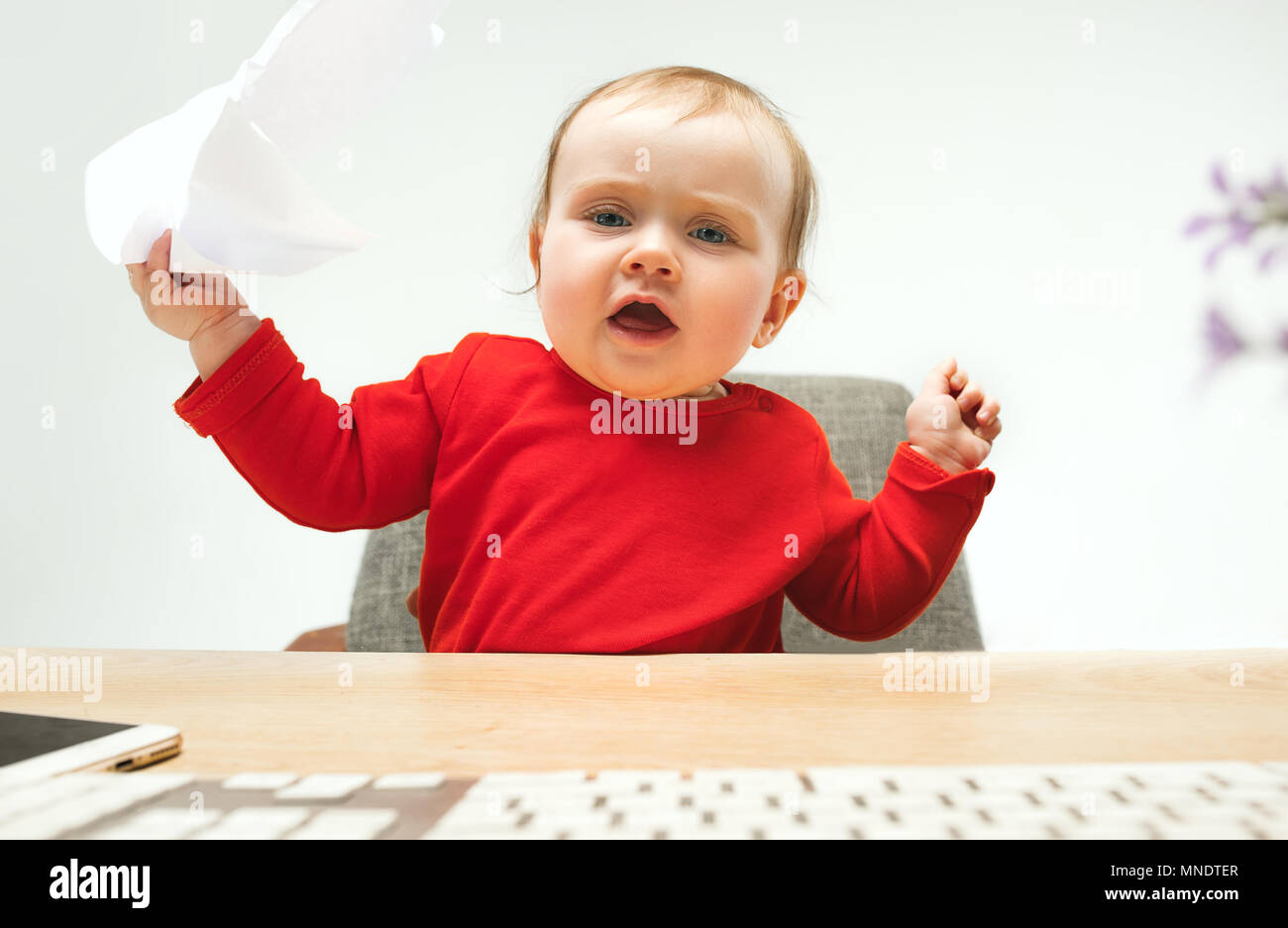 Happy child baby girl toddler sitting with keyboard of computer ...