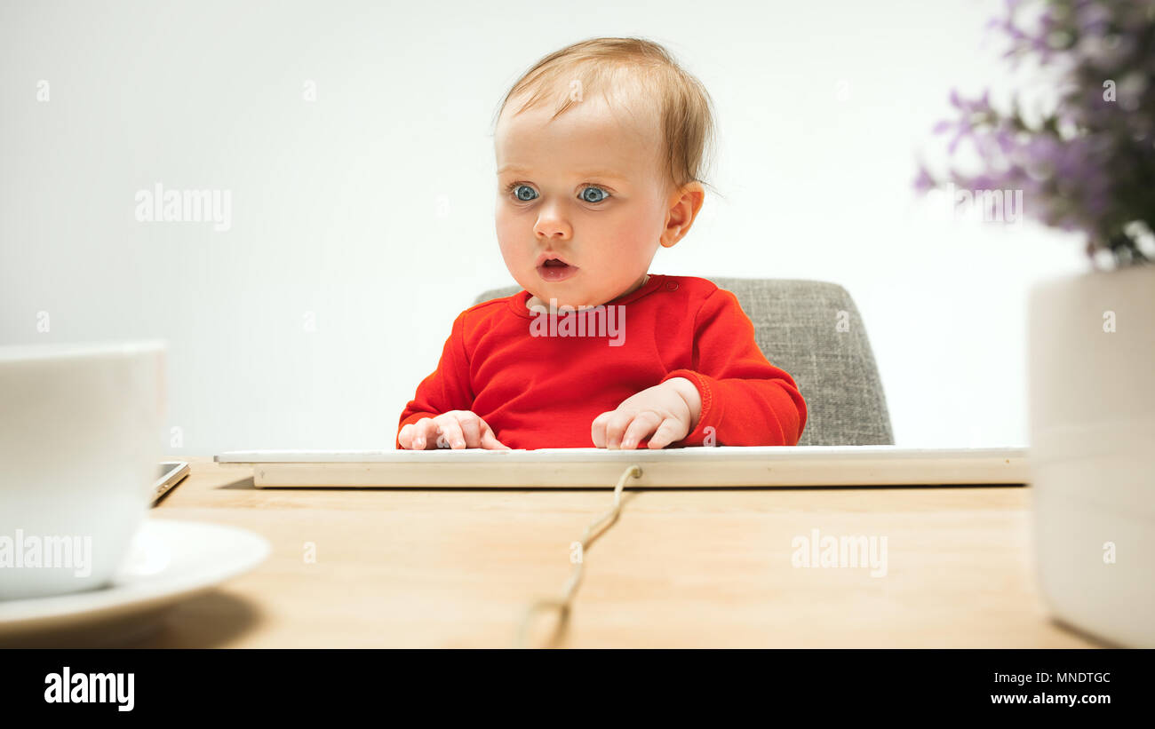 Happy child baby girl toddler sitting with keyboard of computer ...