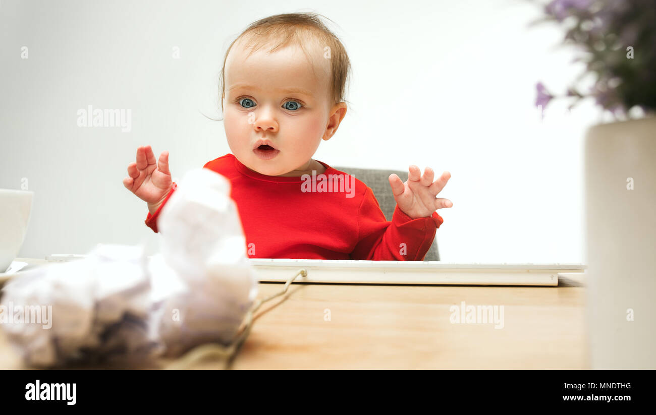 Happy child baby girl toddler sitting with keyboard of computer ...