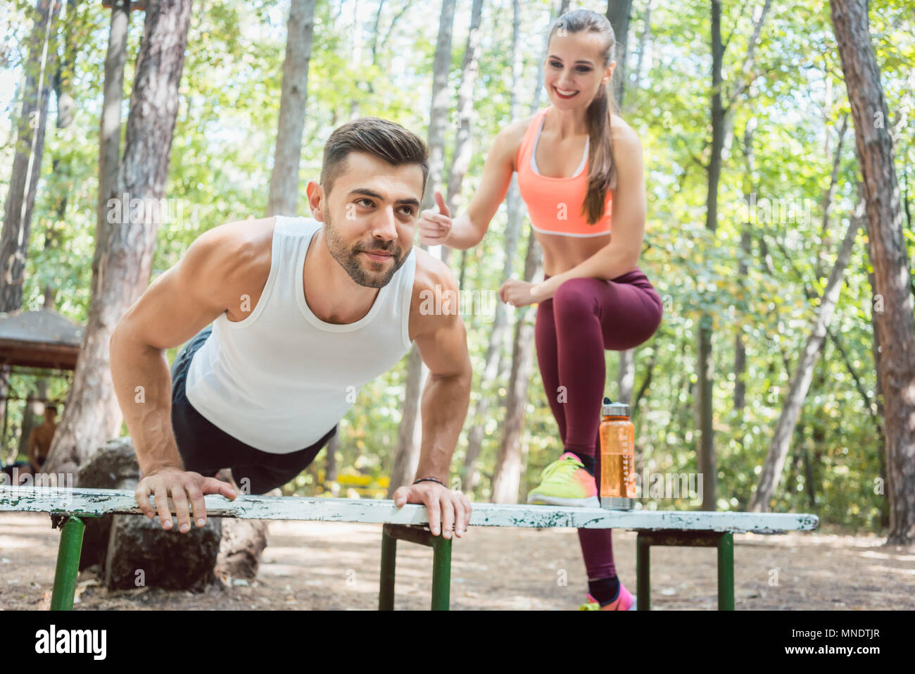 Sporty man doing push-up in an outdoor gym Stock Photo - Alamy