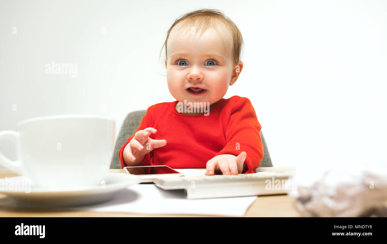 Happy child baby girl toddler sitting with keyboard of computer ...