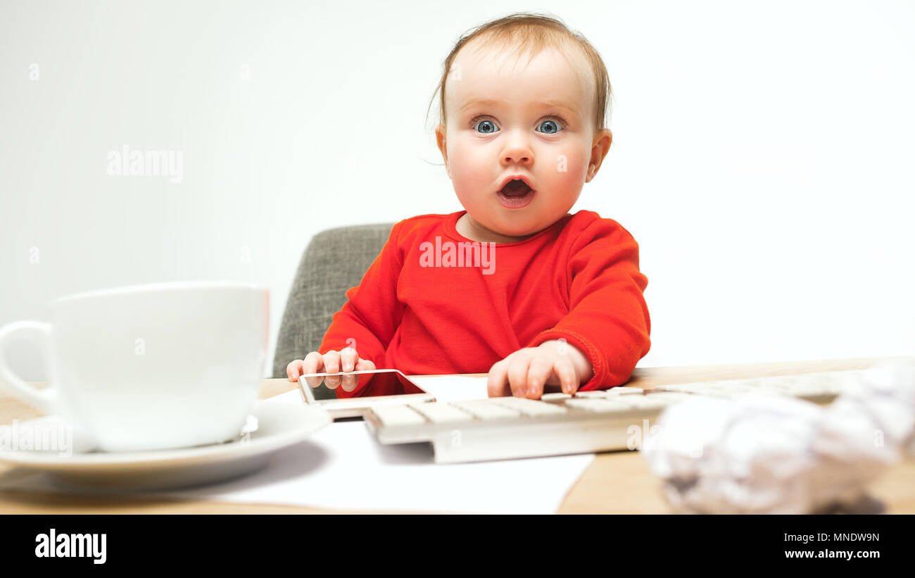 Happy child baby girl toddler sitting with keyboard of computer ...