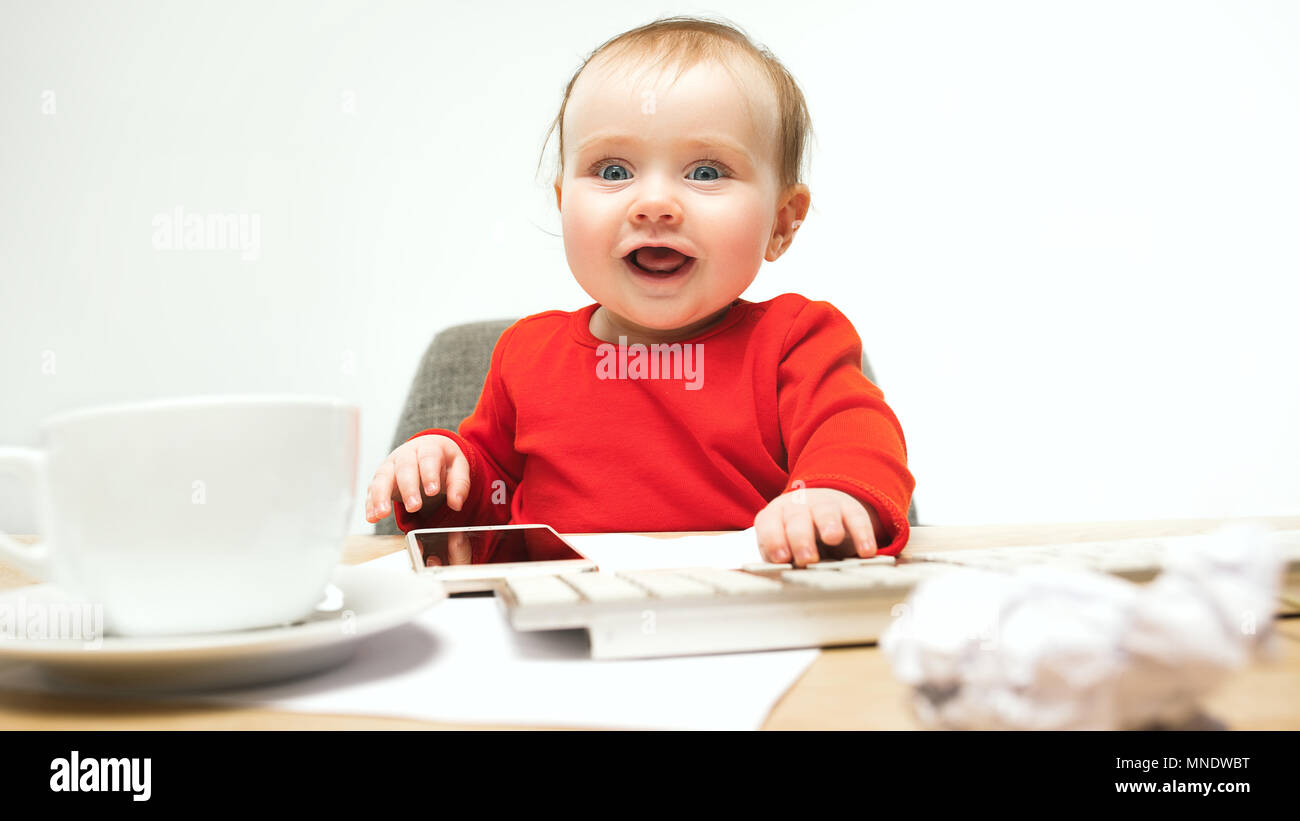 Happy child baby girl toddler sitting with keyboard of computer ...