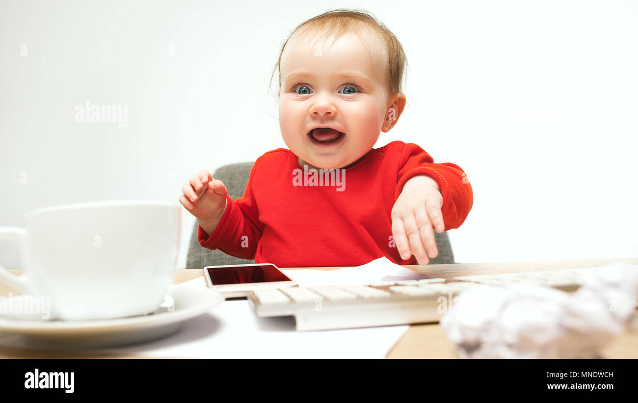 Happy child baby girl toddler sitting with keyboard of computer ...