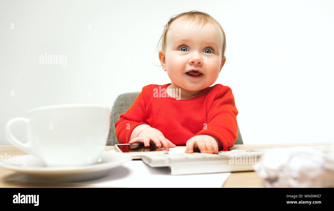 Happy child baby girl toddler sitting with keyboard of computer ...